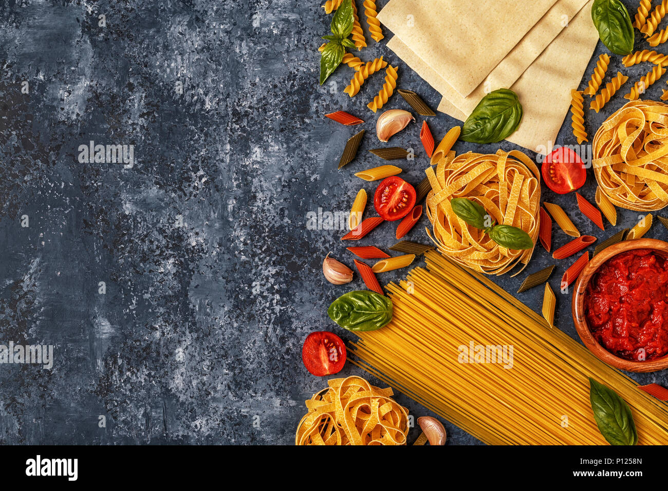 Italian food background with pasta, spices and vegetables. Top view ...