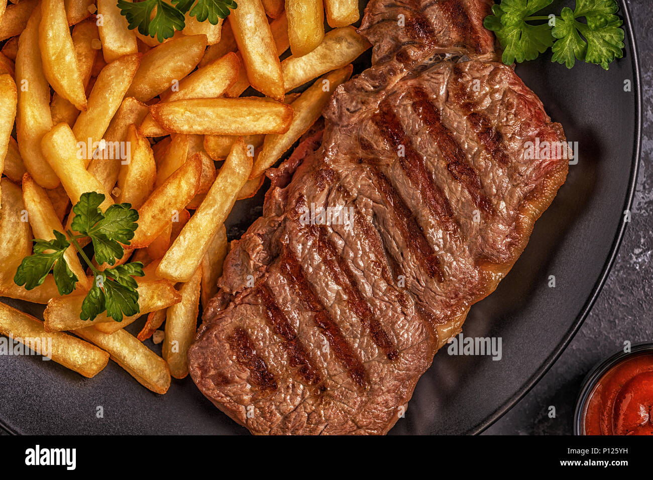 Beef barbecue steak with french fries, top view Stock Photo - Alamy