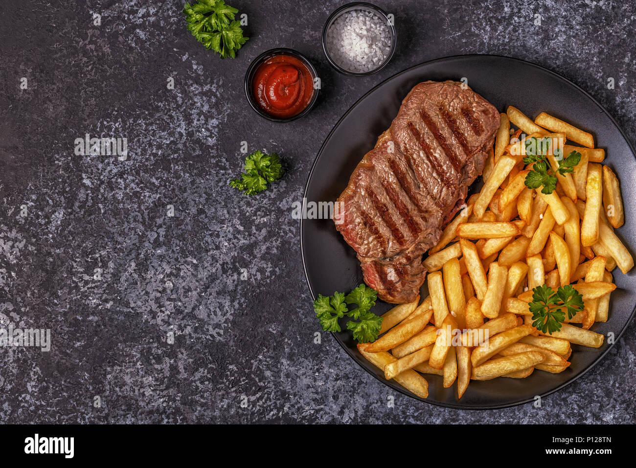 Beef barbecue steak with french fries, top view Stock Photo - Alamy