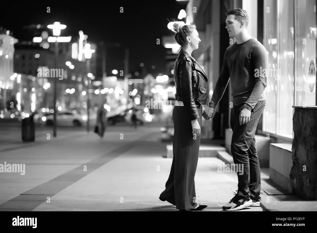 Beautiful couple on a date in a night city outdoor Stock Photo - Alamy