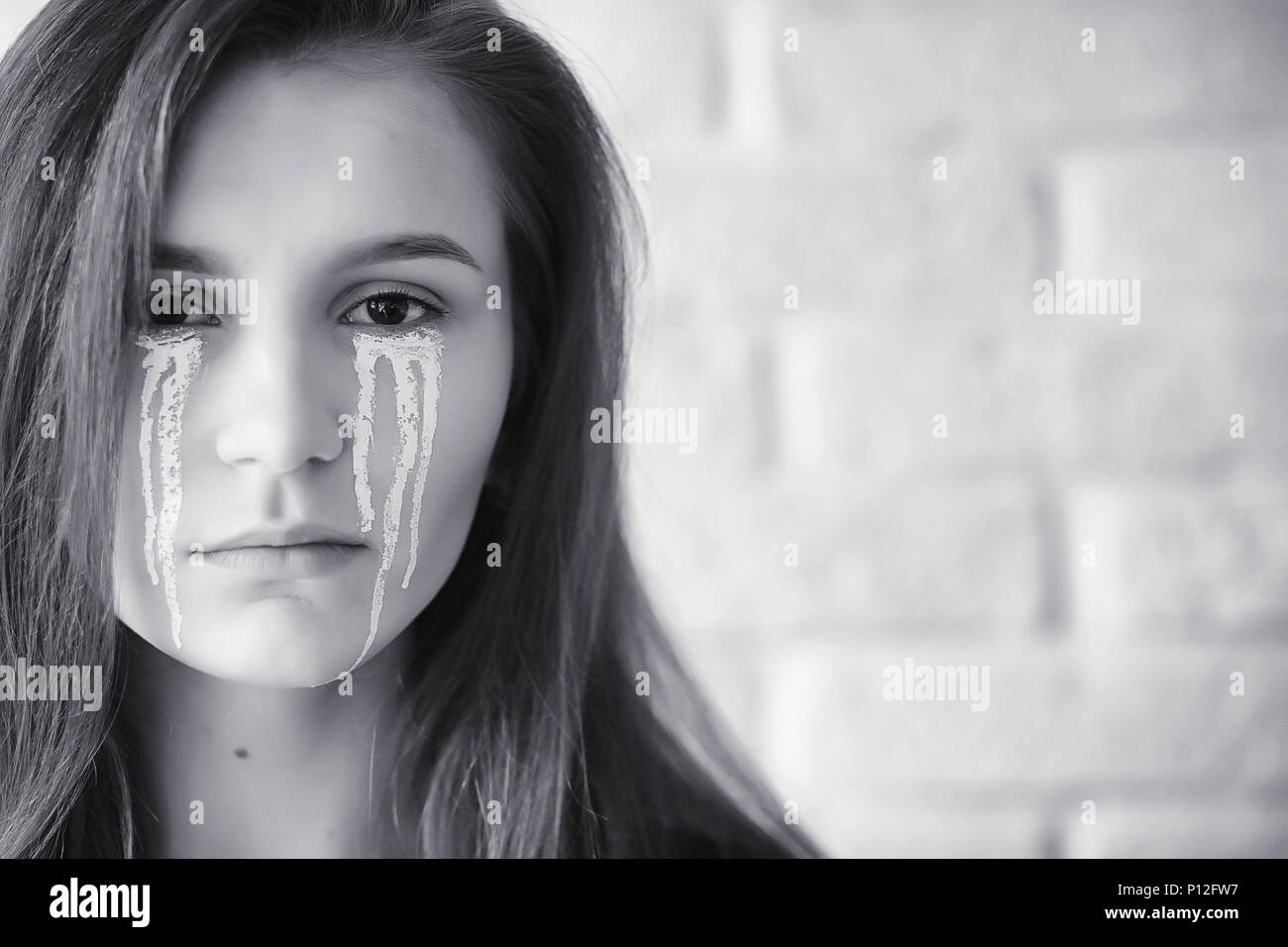 Beautiful girl with tears in eyes. Young girl with painted tears posing ...