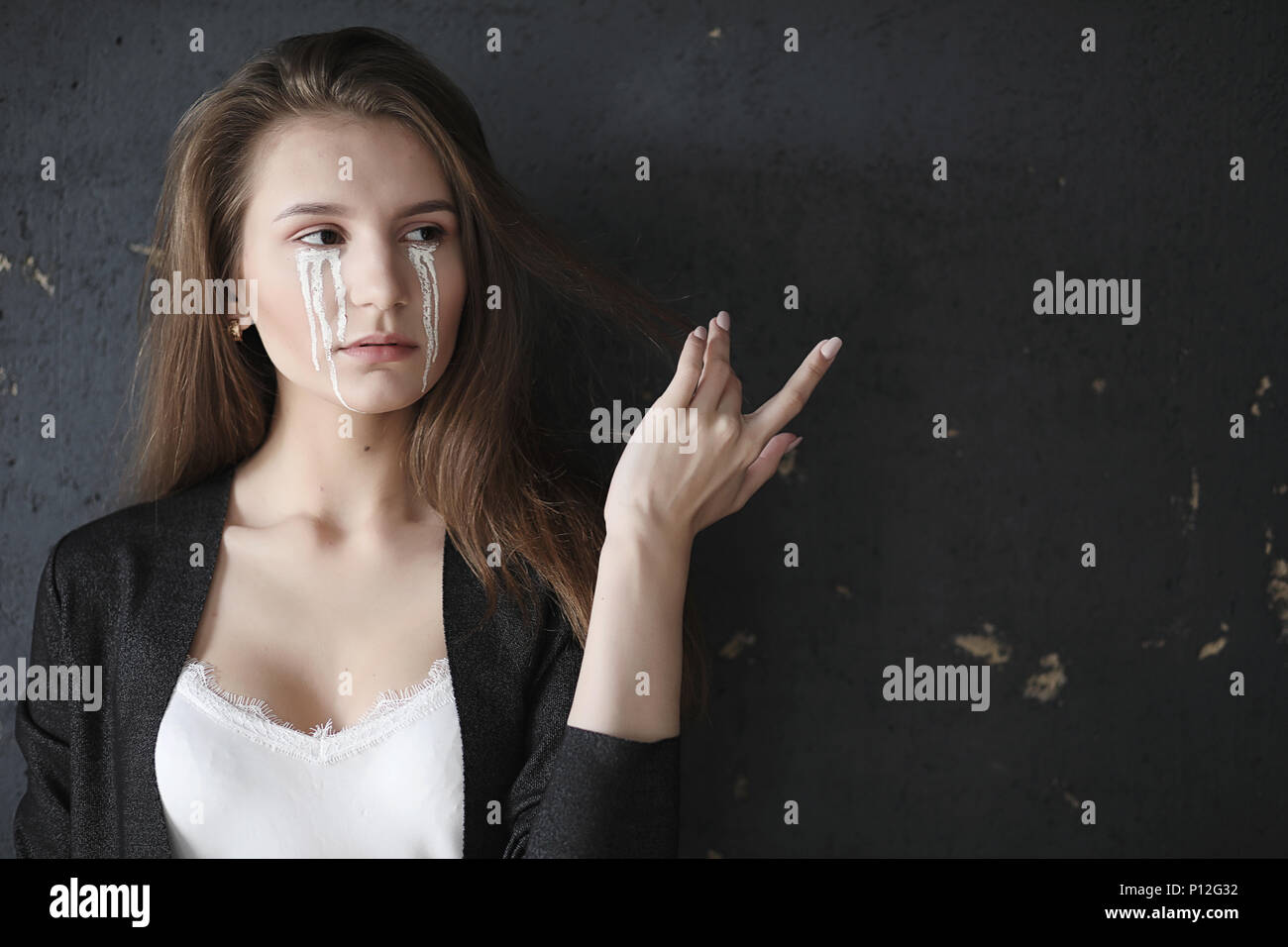 Beautiful girl with tears in eyes. Young girl with painted tears posing ...
