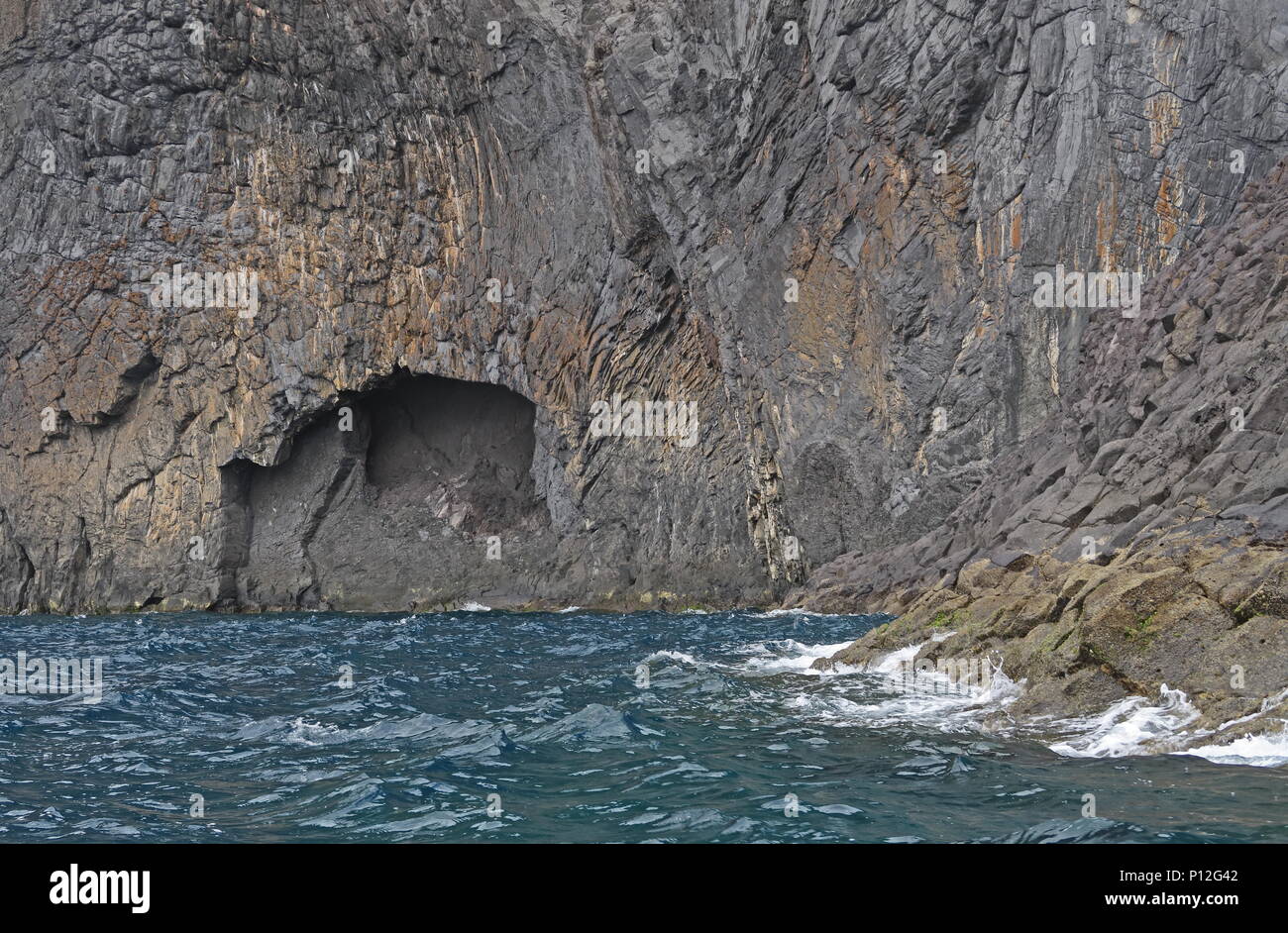 sea cave in cliff face of vulcanic island Desertas Islands, Madeira ...
