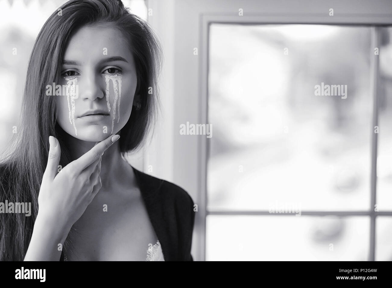 Beautiful girl with tears in eyes. Young girl with painted tears posing ...