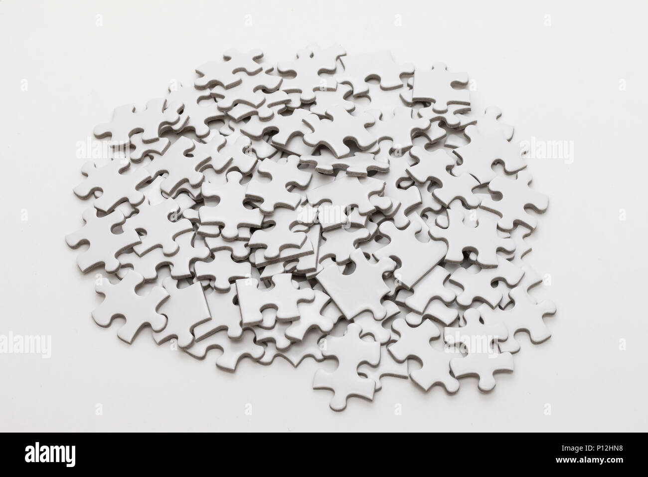 Unfinished white jigsaw puzzle Stock Photo - Alamy