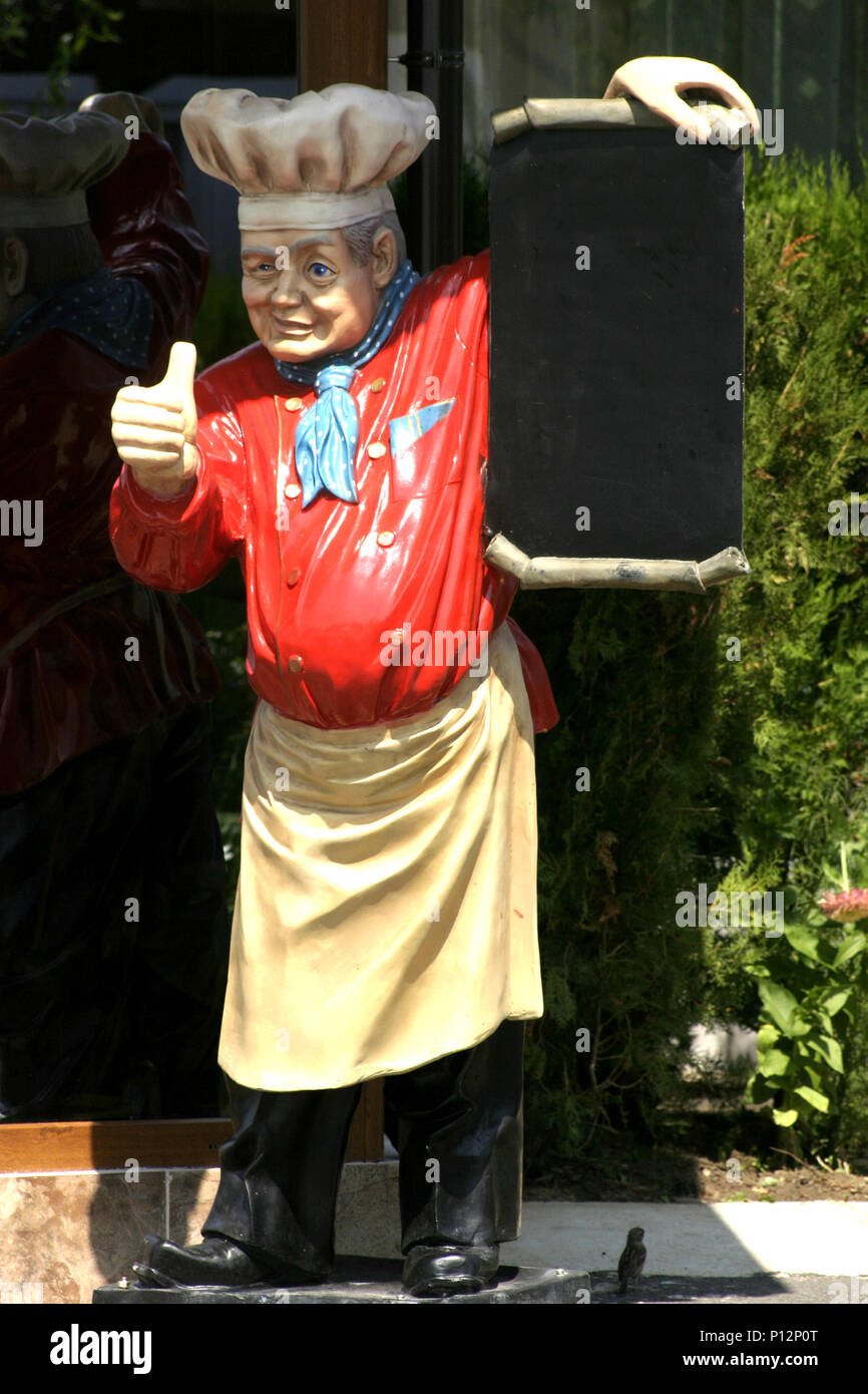 Chef sculpture with menu board in front of restaurant Stock Photo - Alamy