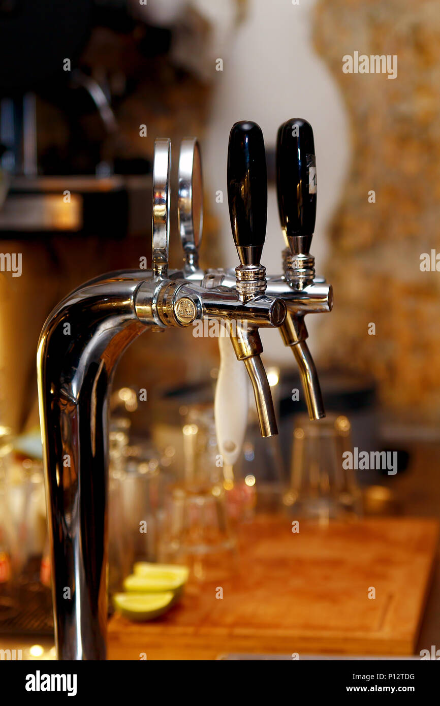 Beer Tap in a Bar. Blur background Stock Photo - Alamy