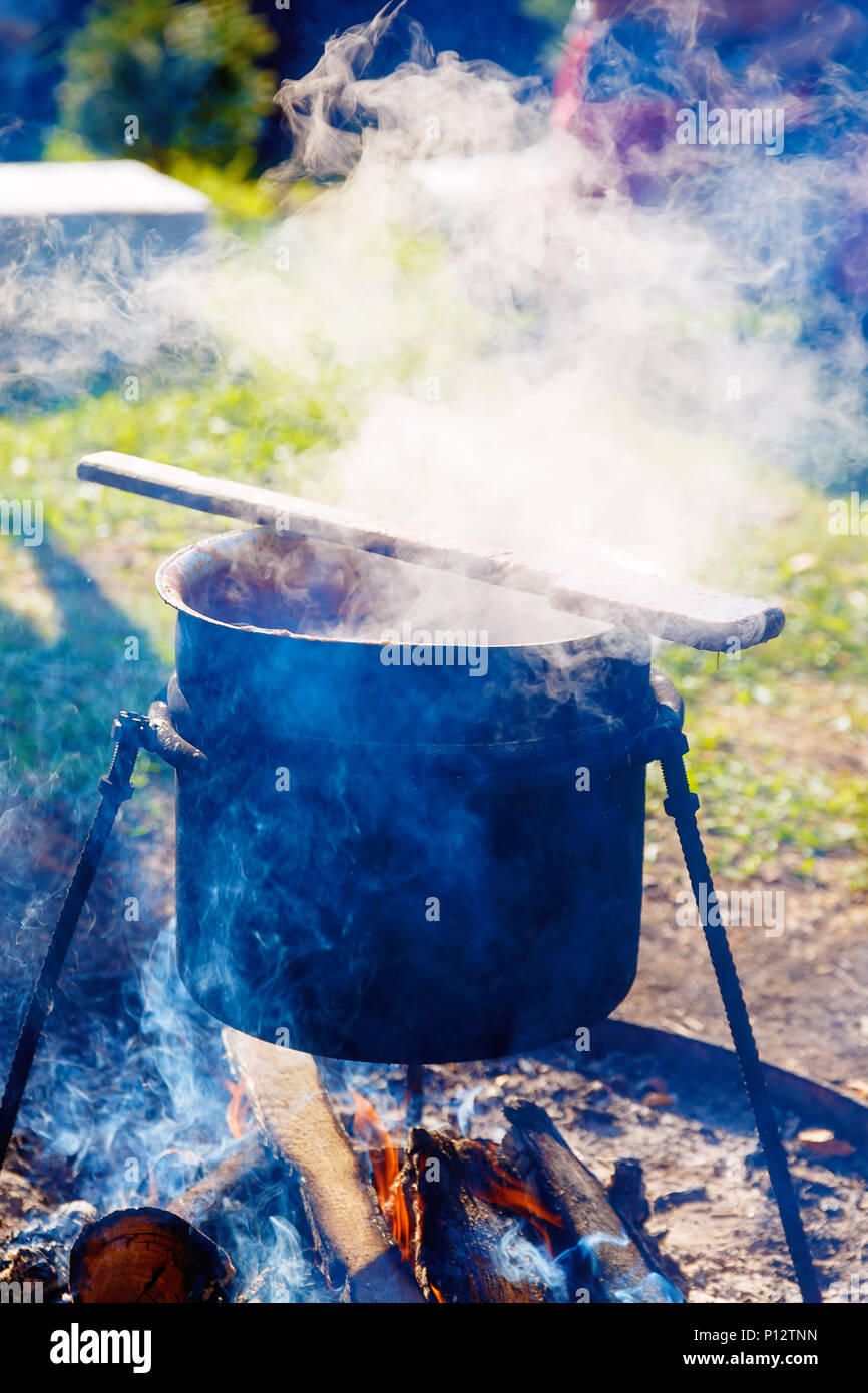 cooking goulash on fire in nature. Blur background Stock Photo - Alamy