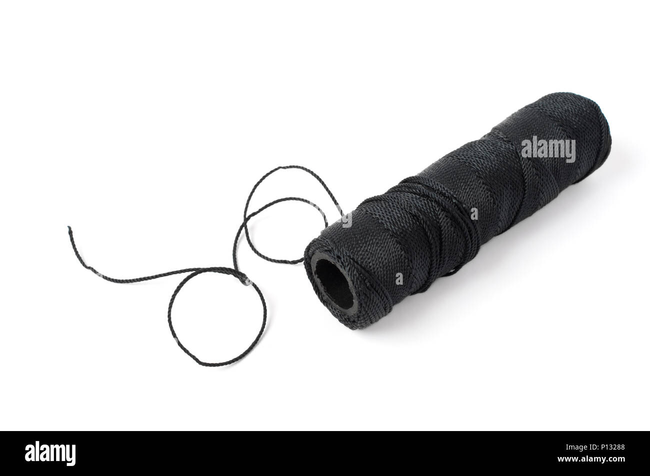 Spool of black string on white background Stock Photo - Alamy