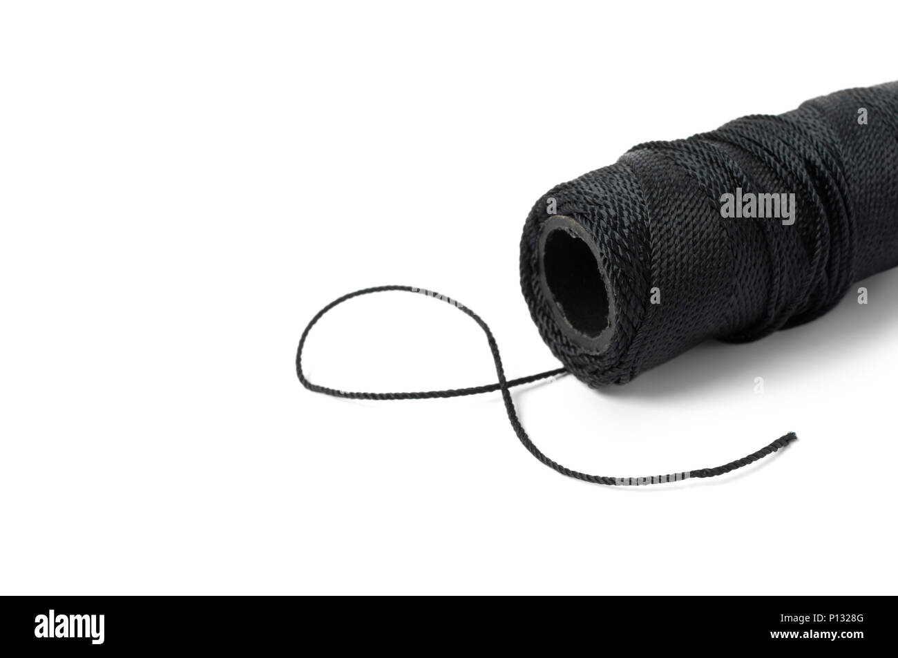 Spool of black string on white background Stock Photo - Alamy