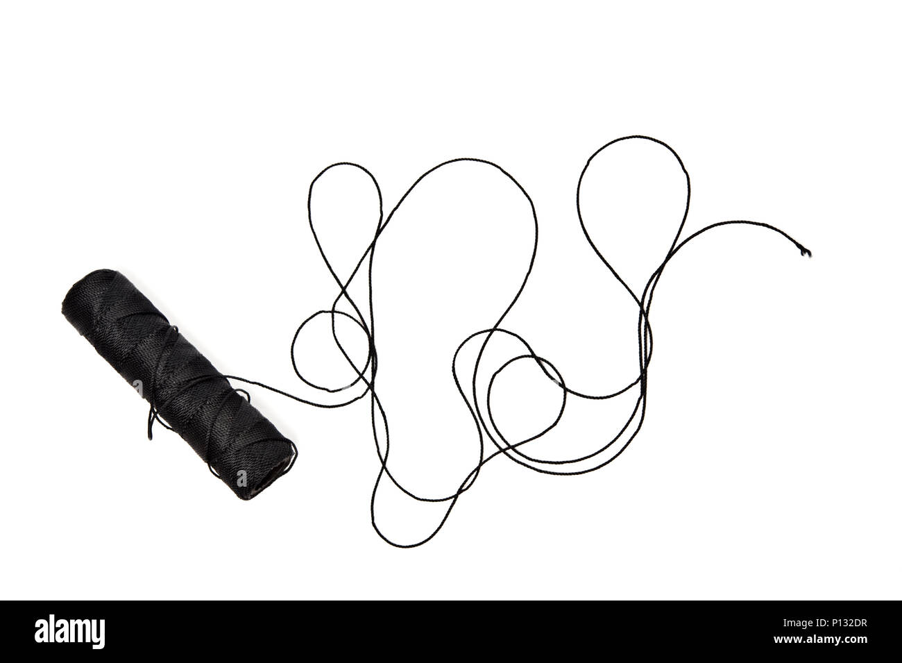 Spool of black string on white background Stock Photo - Alamy