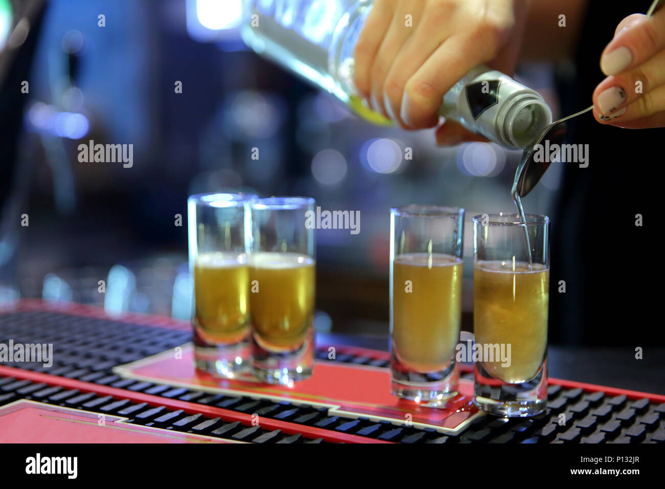 Pouring vodka into a shaker's glass Stock Photo - Alamy