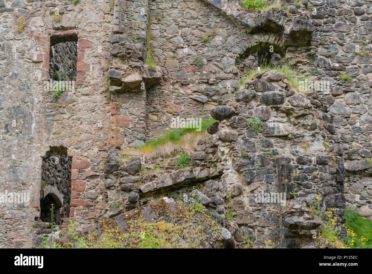 Invergarry, Scotland - June 11, 2012: Tall dark-brown ruined wall with ...