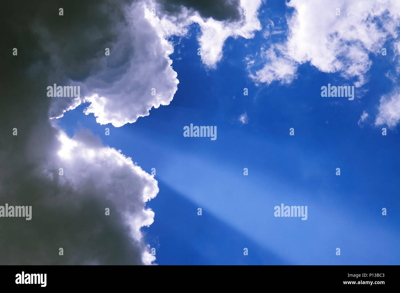 Sun rays through clouds Stock Photo - Alamy