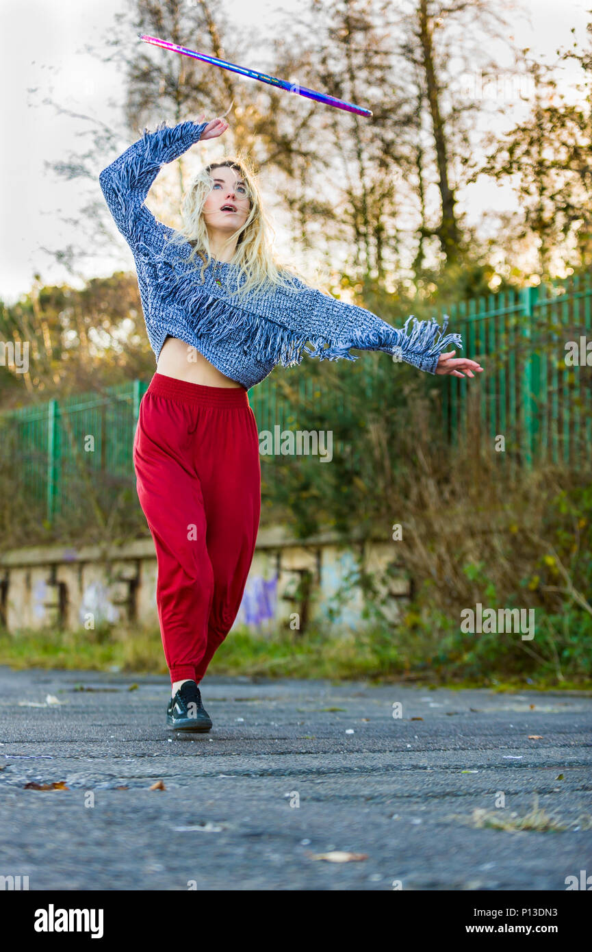 Girl looks up at a hoop, above her head, full length body pose, shot ...