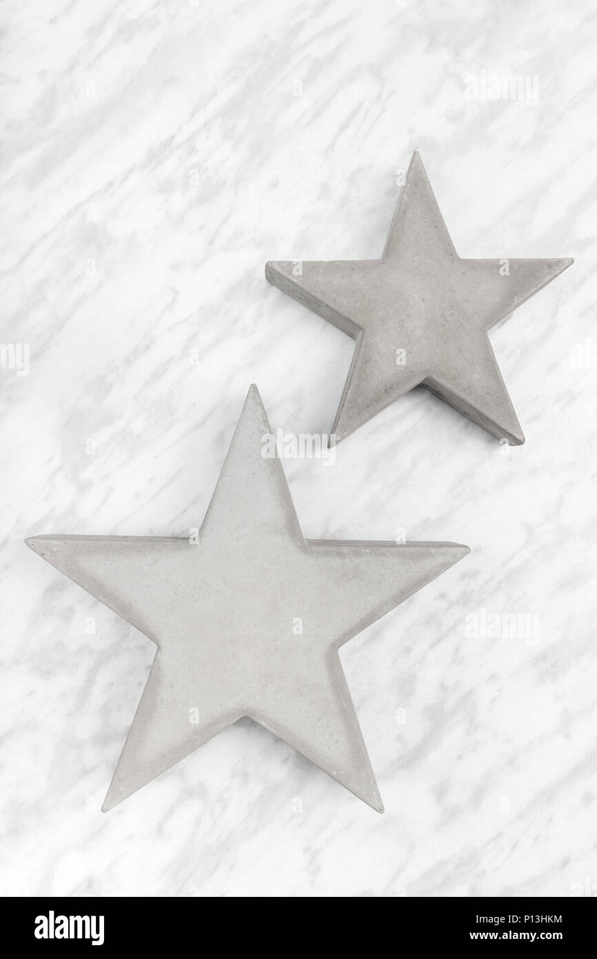 Two concrete stars on marble background. Modern decor Stock Photo - Alamy