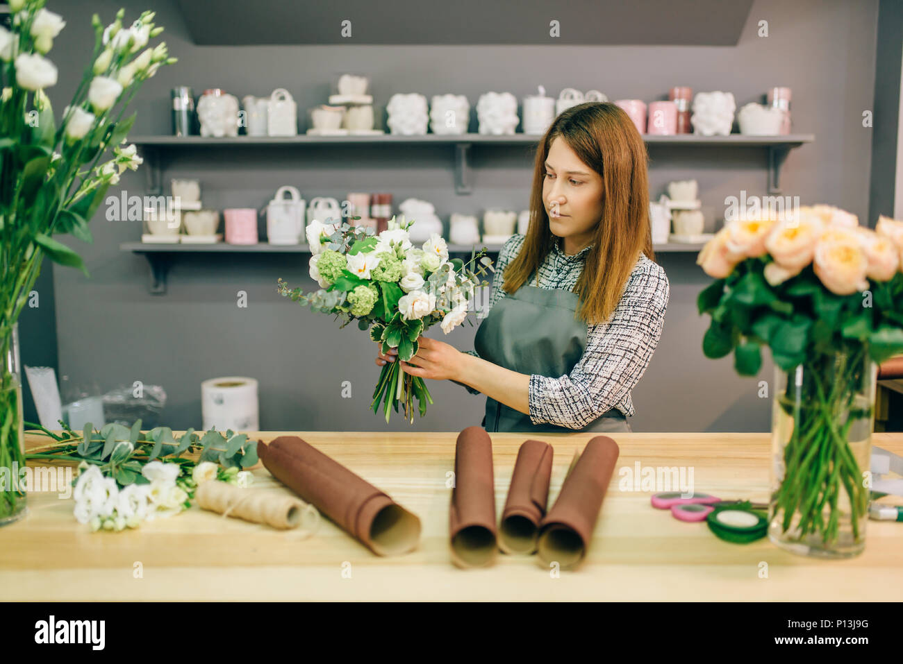 Female florist decorate fresh flower composition. Floral business ...