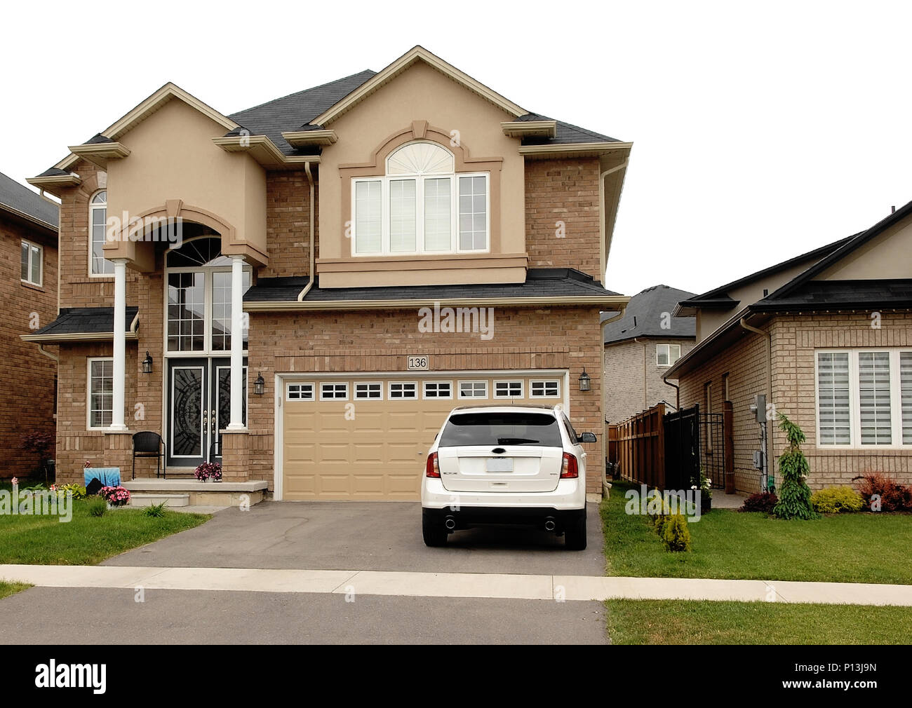 A new big house in a subdivision in Hamilton, Canada with a white car ...