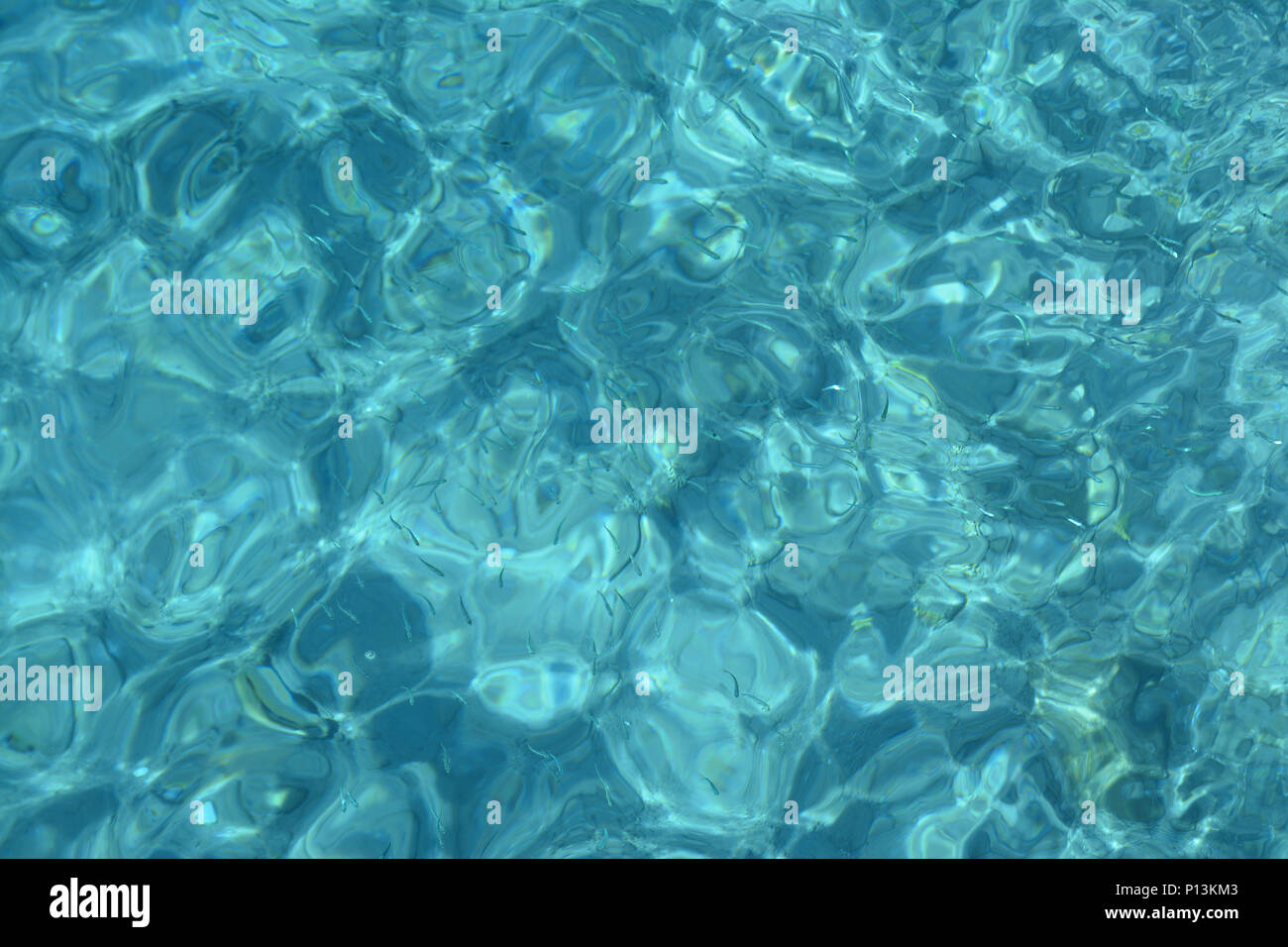 Sea water Pebbles and rocks on beach with pure blue transparent water ...