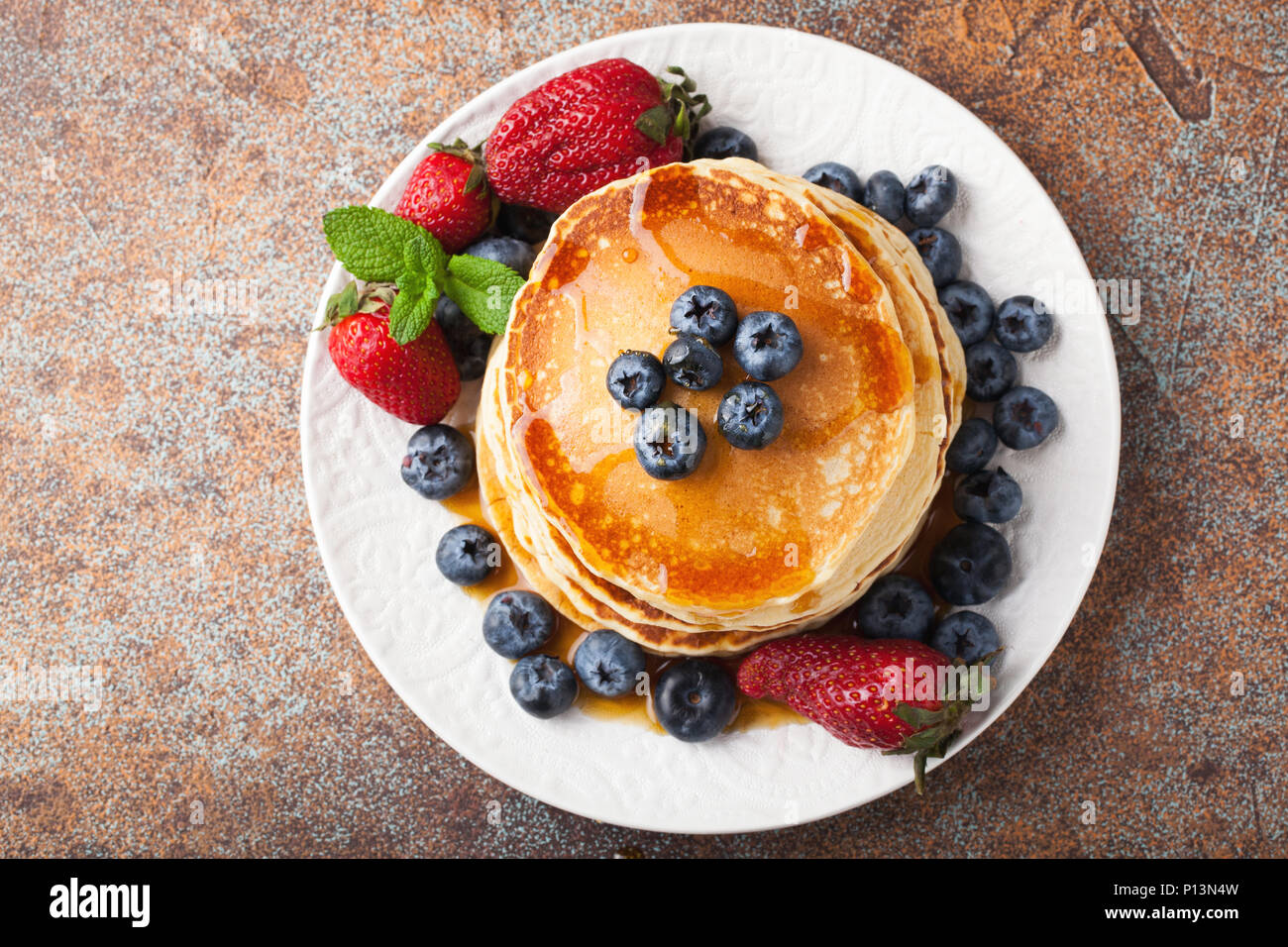 Close-up delicious pancakes, with fresh blueberries, strawberries and ...