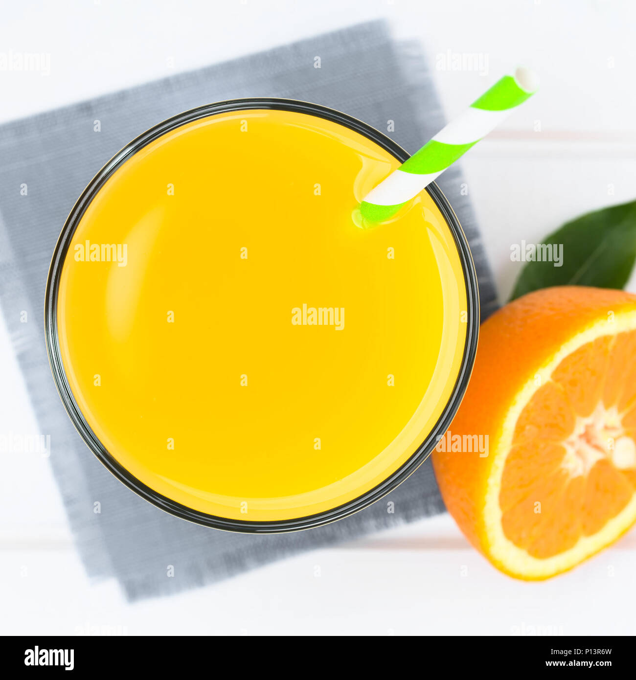 Orange juice in glass with drinking straw, photographed overhead on ...
