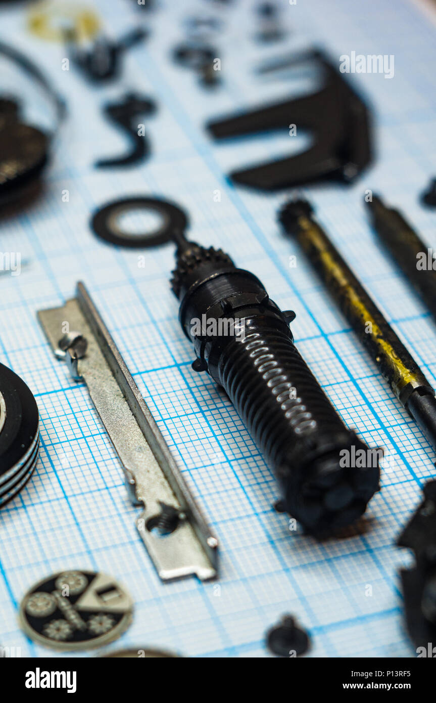 parts are completely disassembled old retro film SLR camera on graph ...