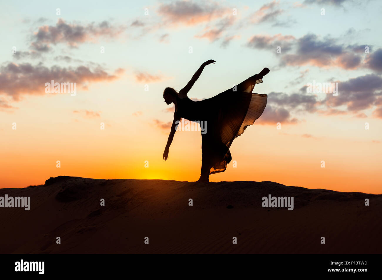 Woman is posing at sunset, she is dancing Stock Photo - Alamy