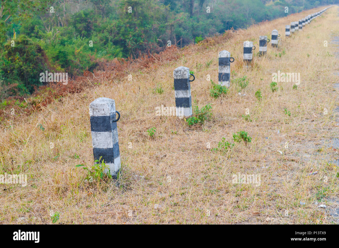 roadside pillar in the surface of natural road Stock Photo - Alamy