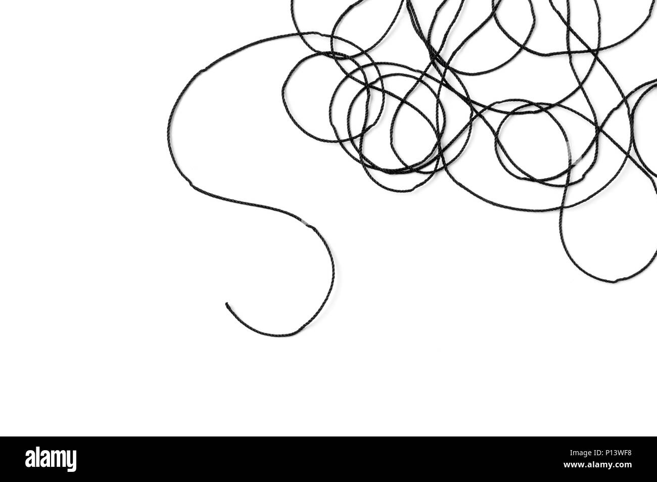 Tangled black thread isolated on white background Stock Photo - Alamy