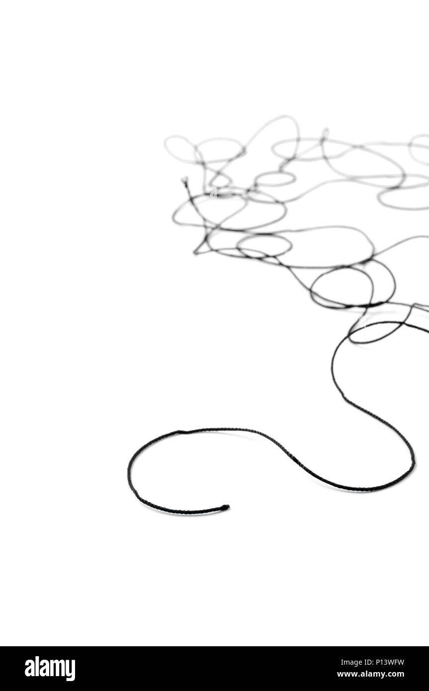 Tangled black thread isolated on white background Stock Photo - Alamy