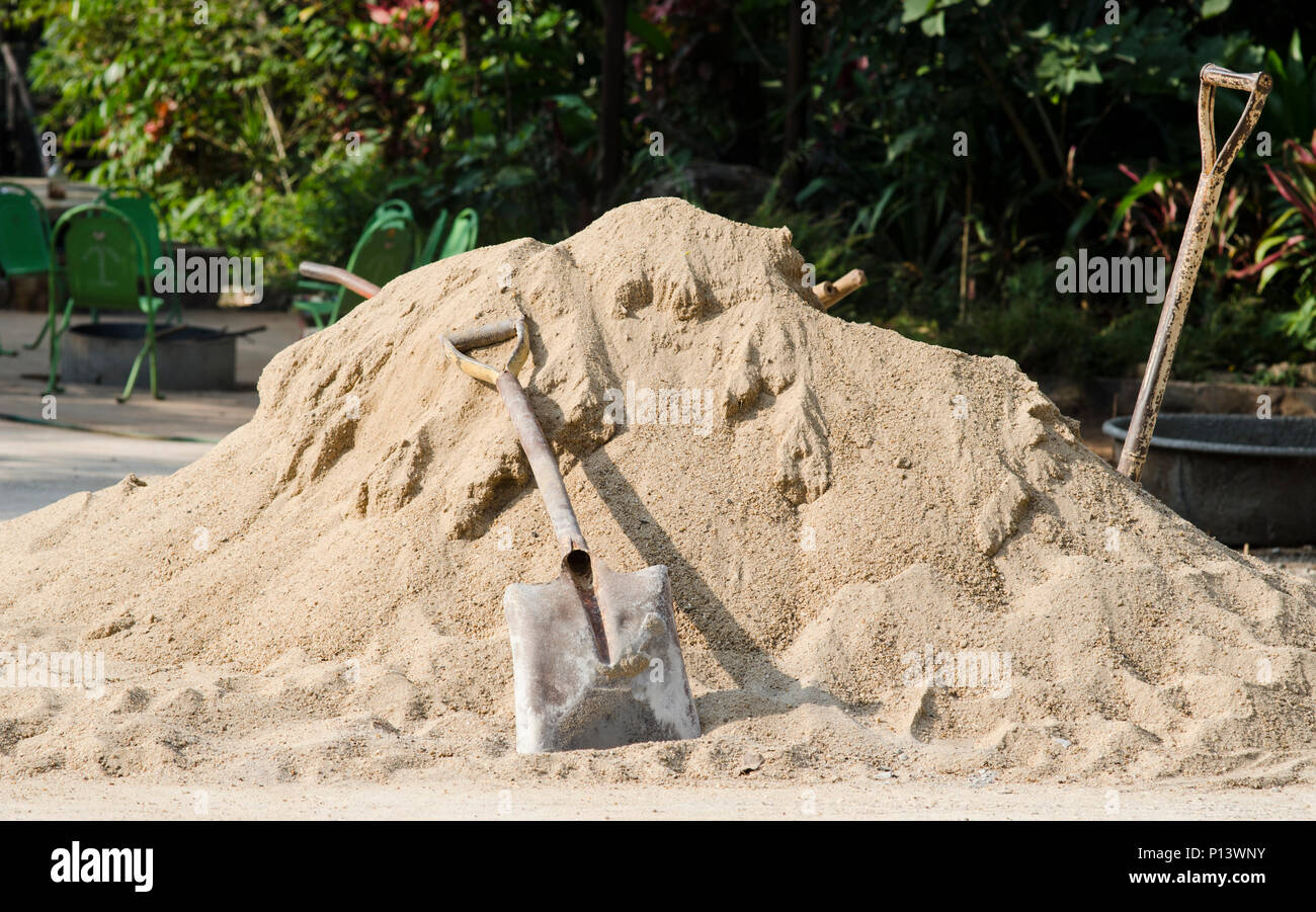 Pile of sand and shovel for construction Stock Photo - Alamy
