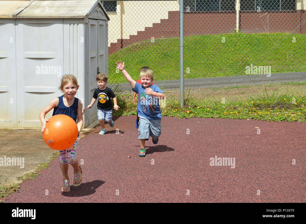 WHEELER ARMY AIRFIELD — Leona Southward, 4, is chased by Andrew Severin ...