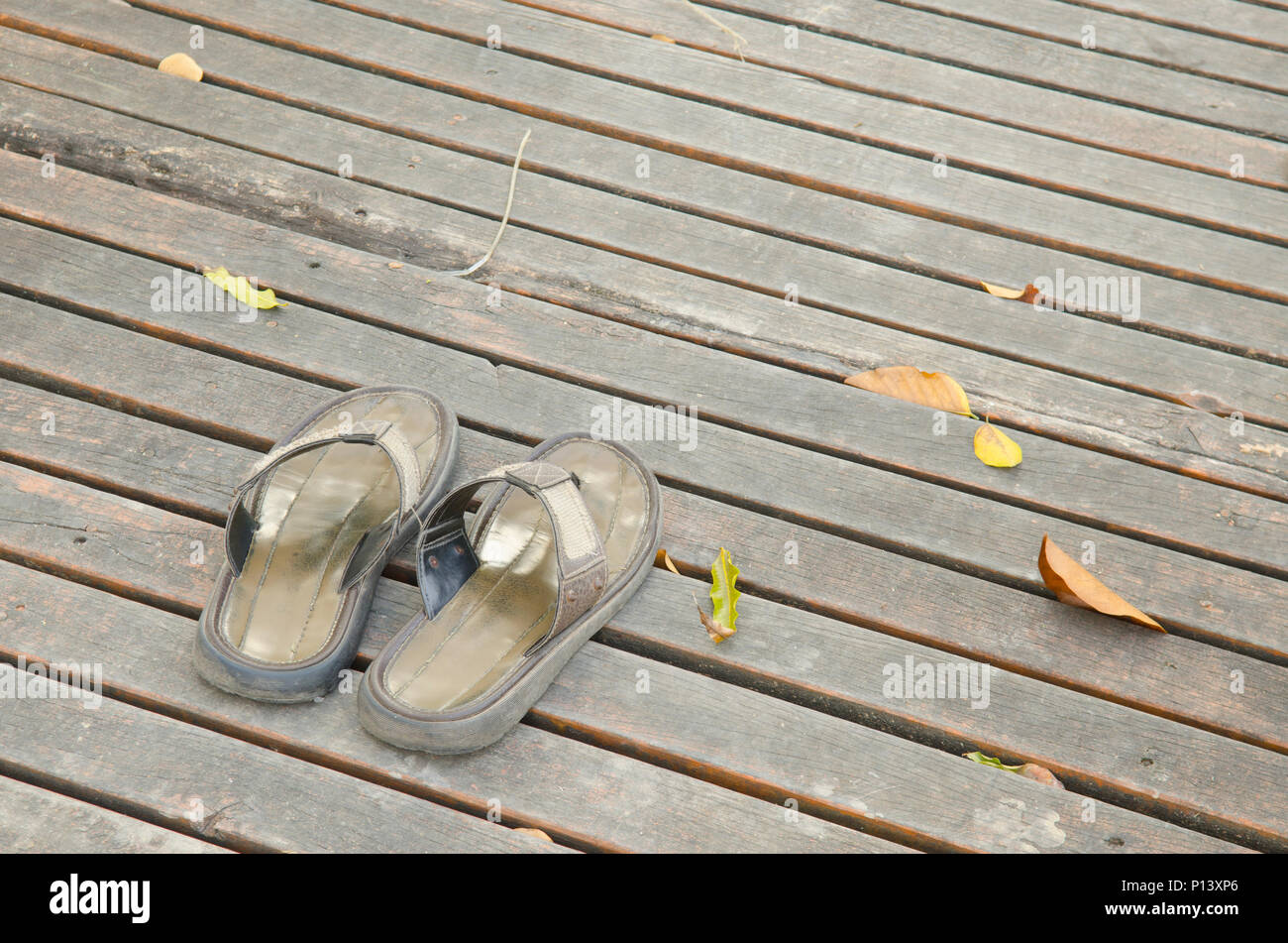 Old Slippers shoes on wooden floor Stock Photo - Alamy