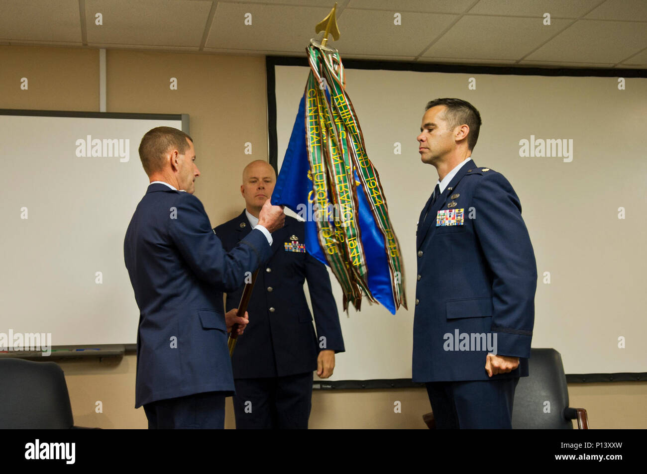 U.S. Air Force Lt. Col. John Robinson presents the guidon to Maj ...