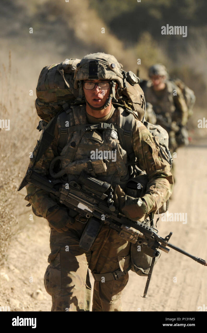 A 5th Battalion, 20th Infantry Regiment, Soldier rucks up a hill during ...