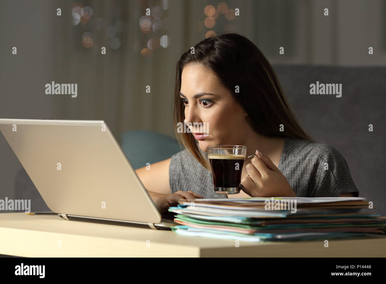 Over excited entrepreneur working hard late hours holding a coffee cup ...