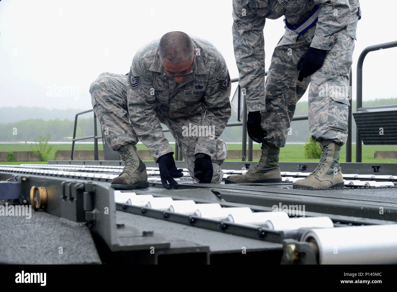 Tech Sergeant Jose Zayas and Senior Airman Andrew Conover, tries to ...