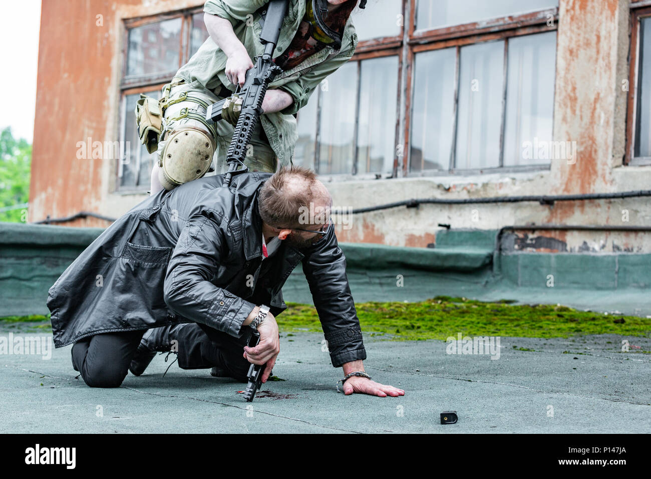 Gunpoint a man lying on the ground hi-res stock photography and images ...