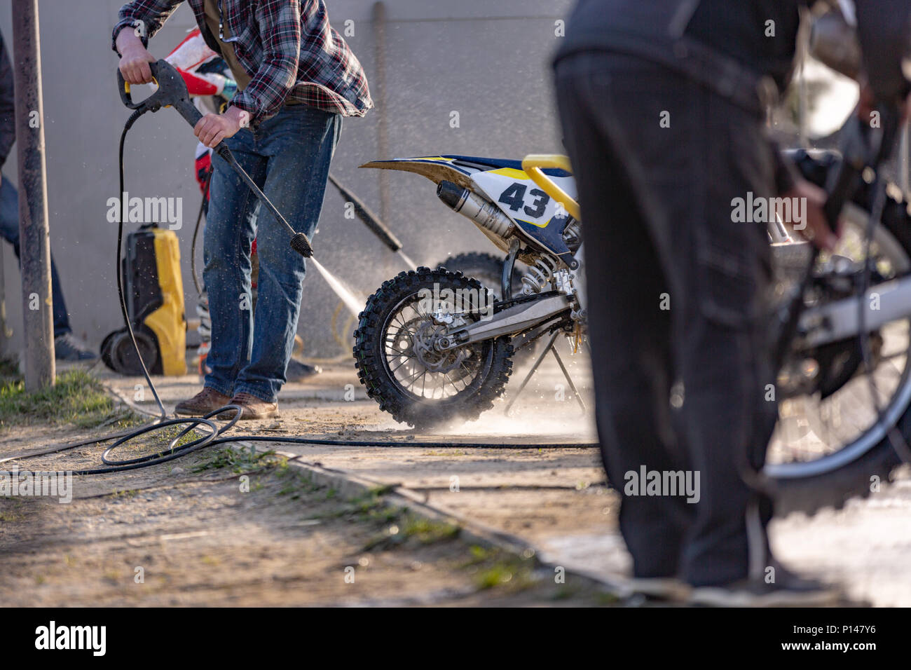 Bike rider washing his motorcycle Stock Photo - Alamy