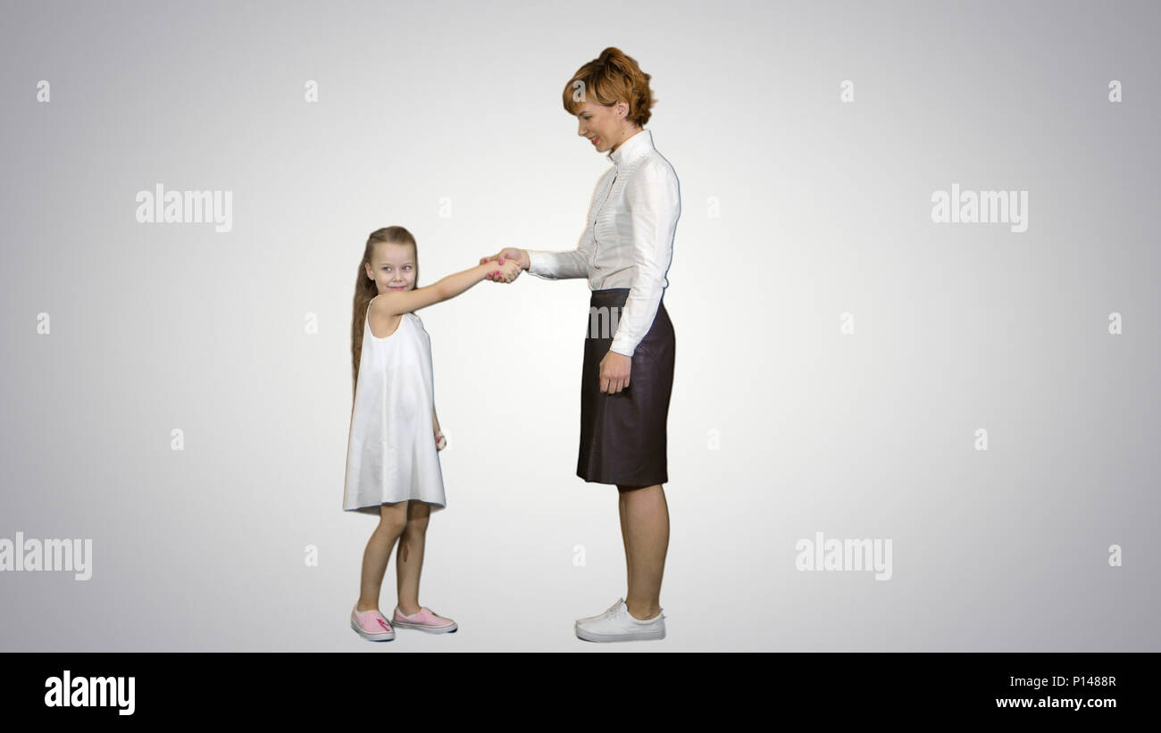 Mother and child shake hands on white background Stock Photo - Alamy