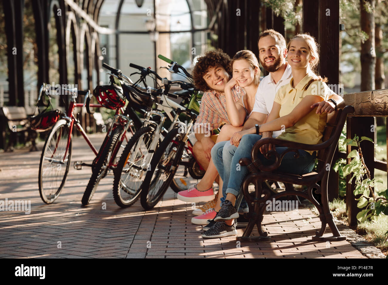 Group of smiling friends looking at camera. Young cheerful friends ...