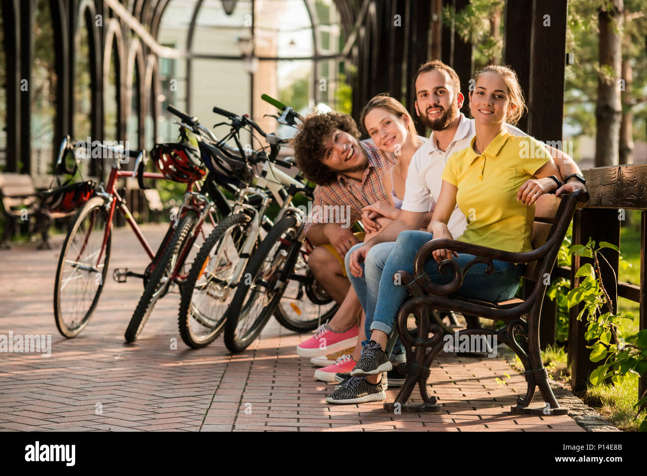 Group of cute friends resting in park. Happy group of friends talking ...