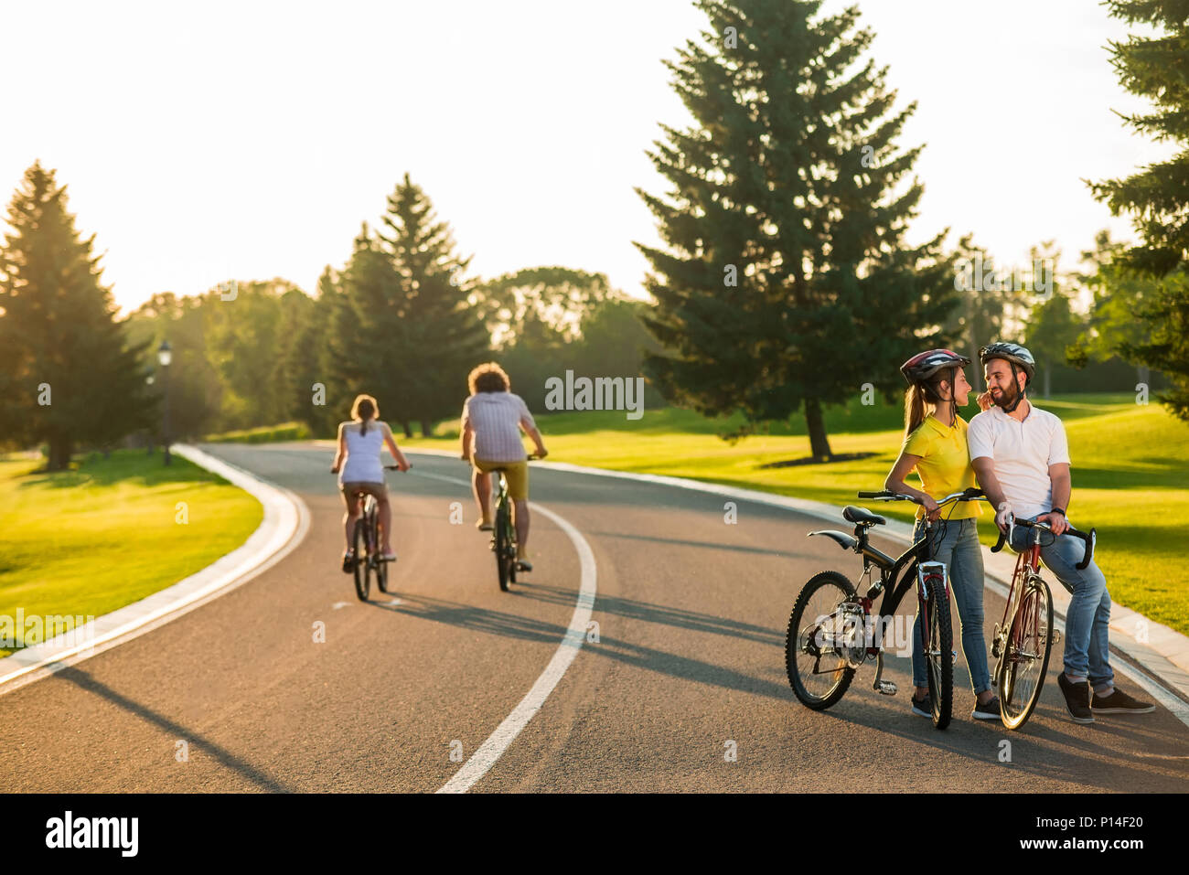 Happy romantic couple with bicycle outdoors. Couple in love. Young ...