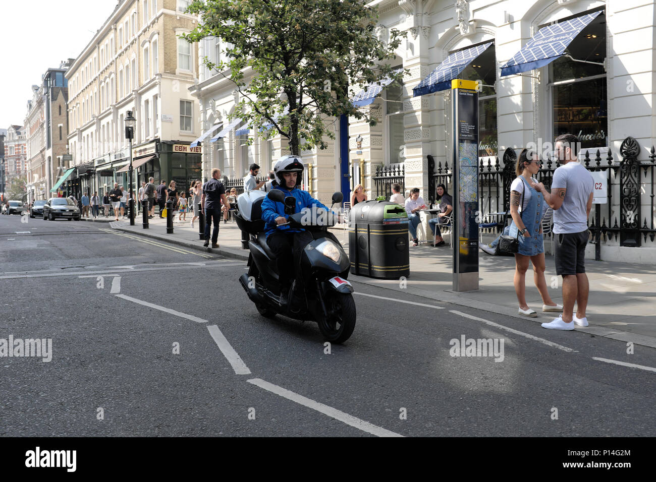 Moped scooter delivery rider, London, England, UK Stock Photo - Alamy