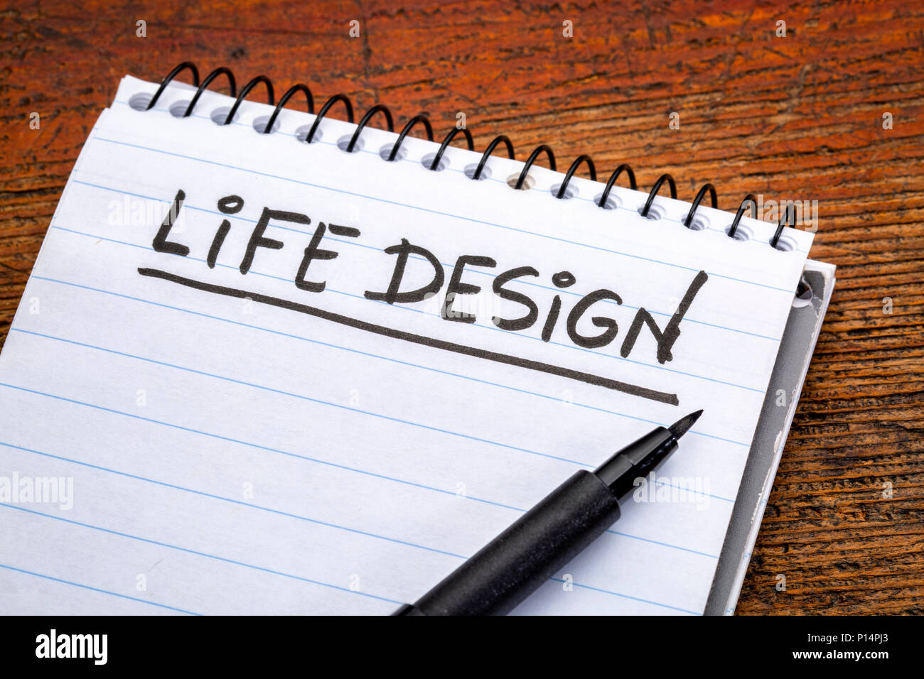 life design - handwriting in a spiral notebooks against grunge wood ...