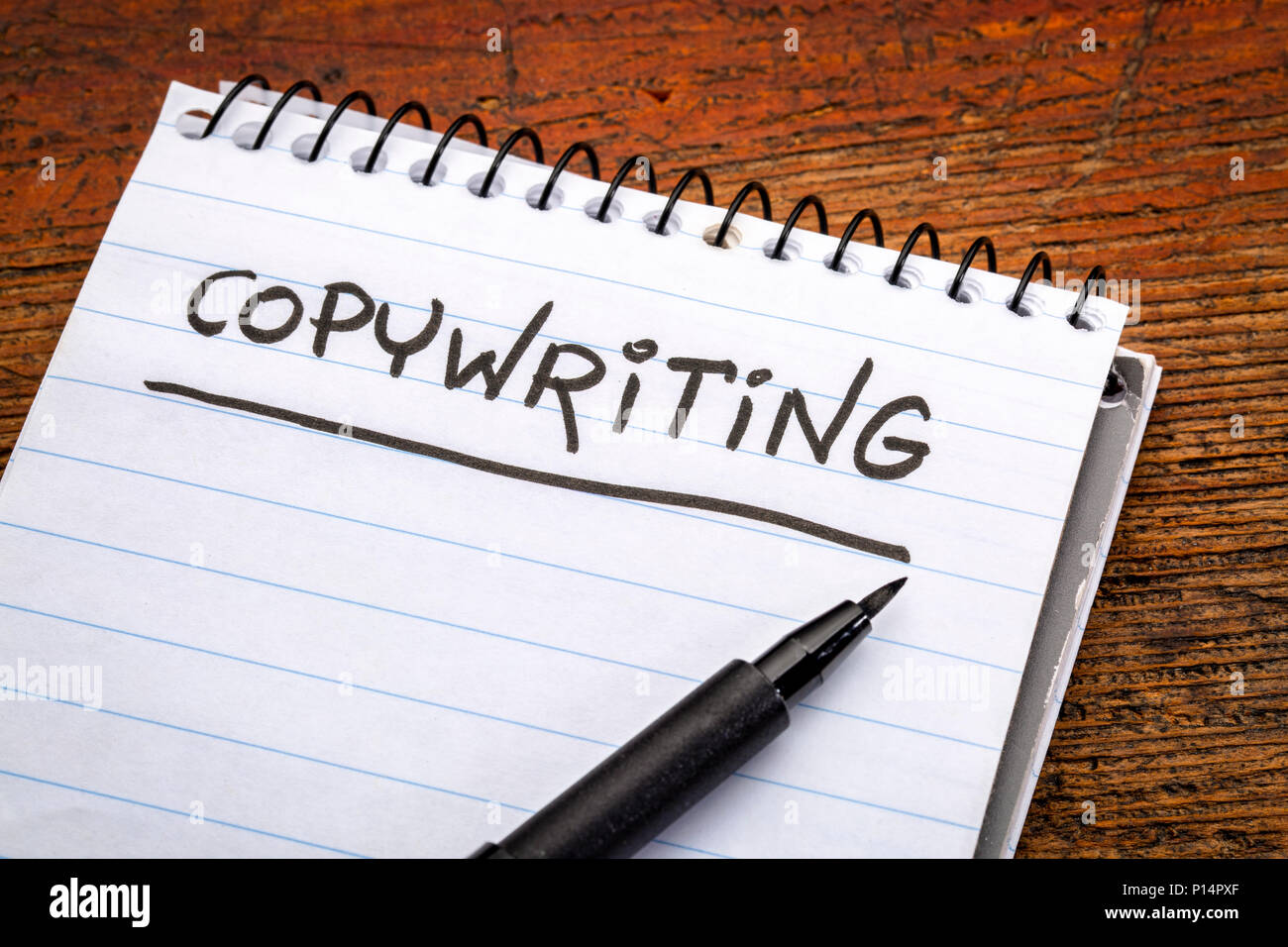 copywriting - handwriting in a spiral notebooks against grunge wood ...