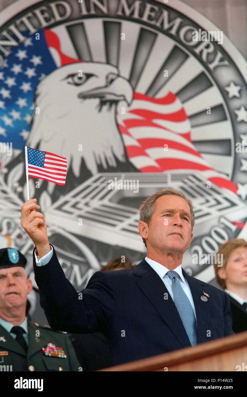 President George W. Bush holds up a small American flag Thursday, Oct ...