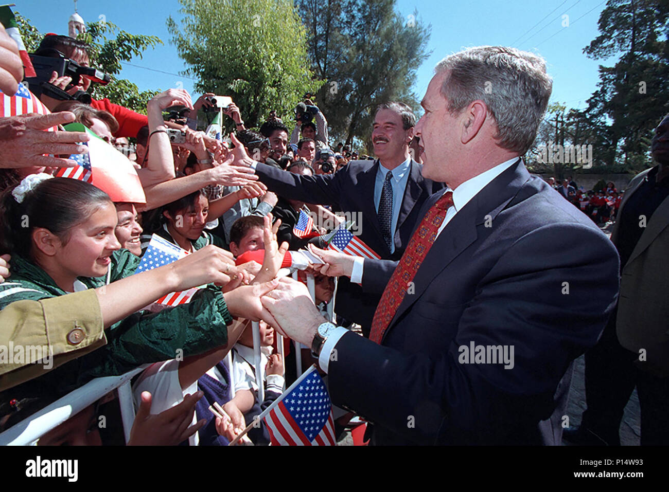 President George W. Bush and President Vicente Fox greet spectators Feb ...
