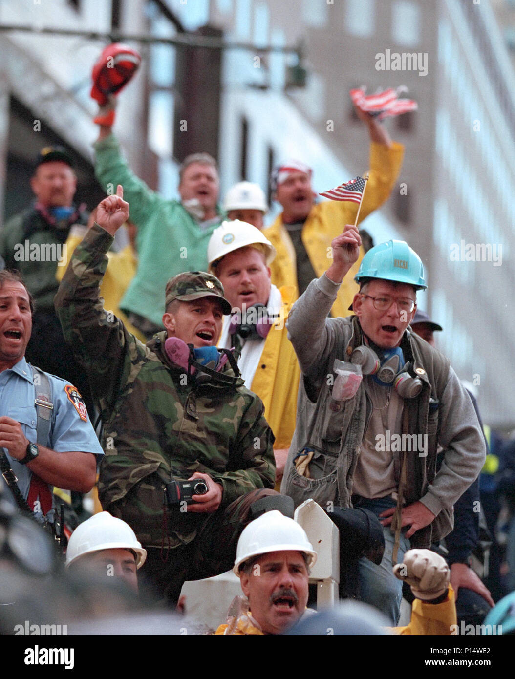 Rescue and emergency personnel rally around President George W. Bush ...