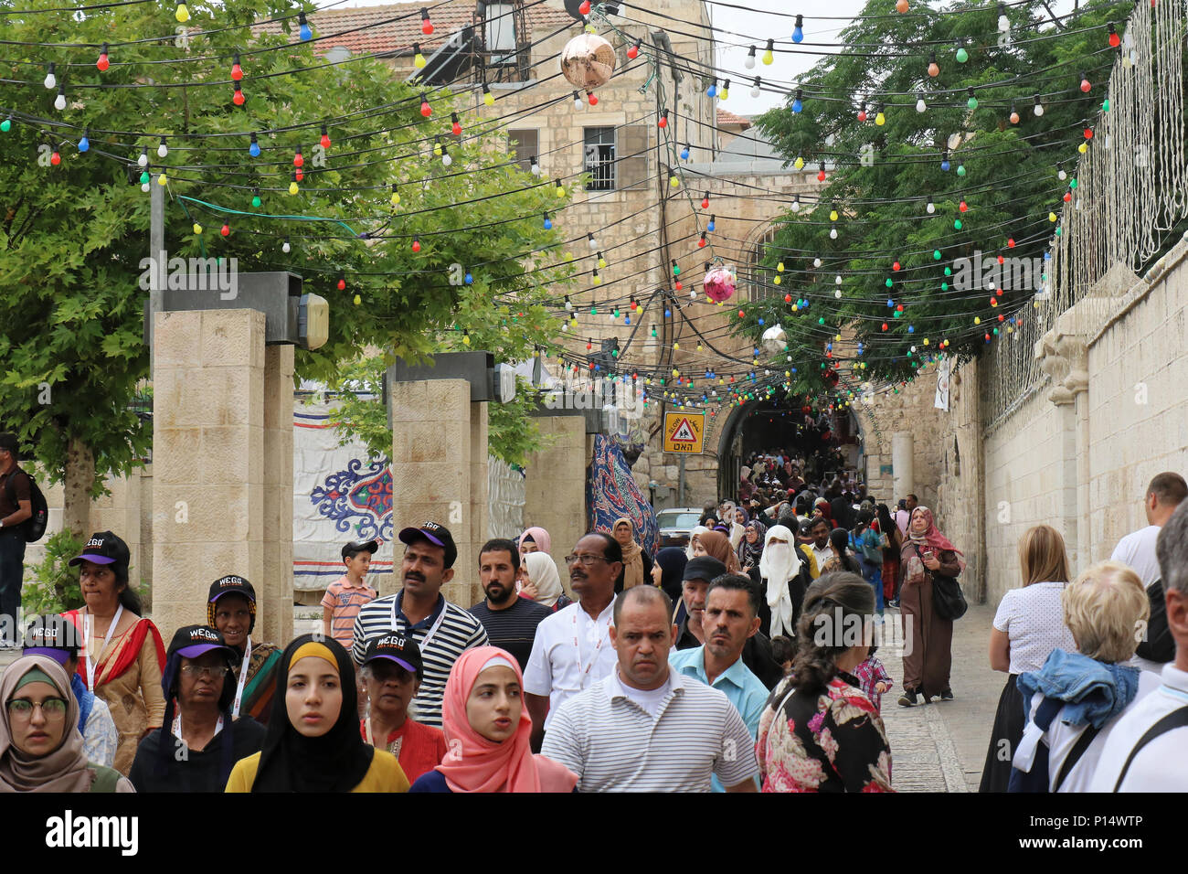 People walking through old city street in Jerusalem during Muslim Holy ...